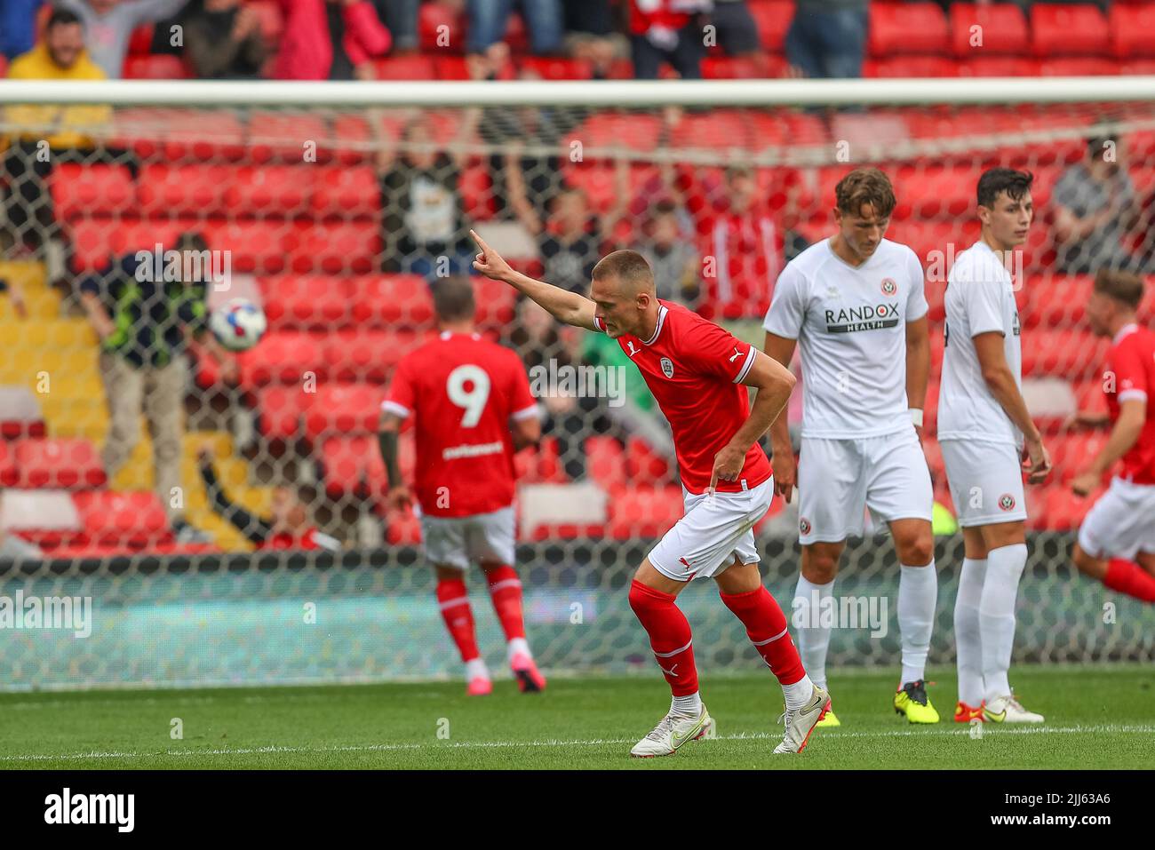 Josh Benson #10 of Barnsley celebrates his free kick to make it 2-1 ...