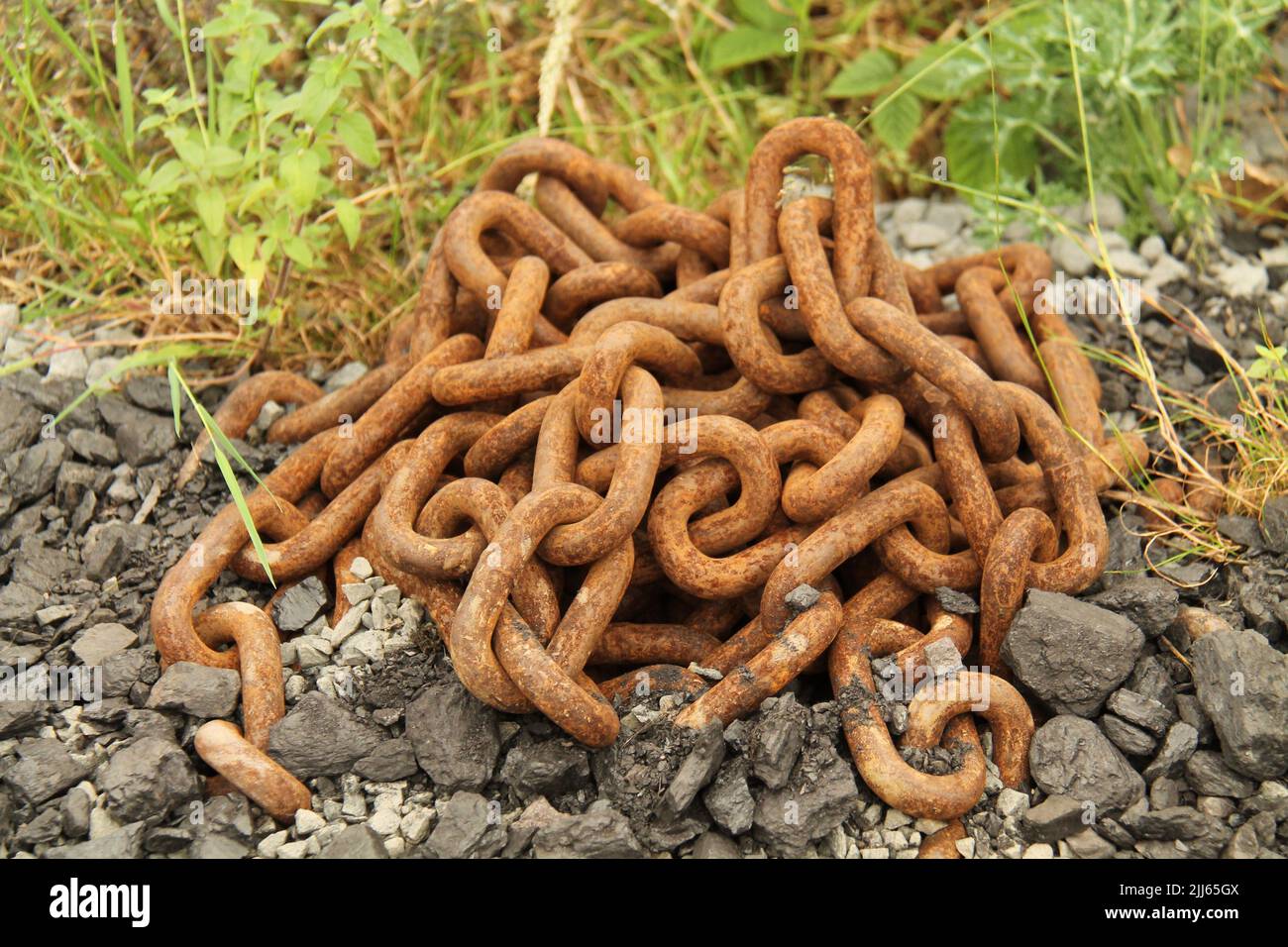 A Large Rusty Chain Being Used as a Garden Decoration Stock Photo - Alamy