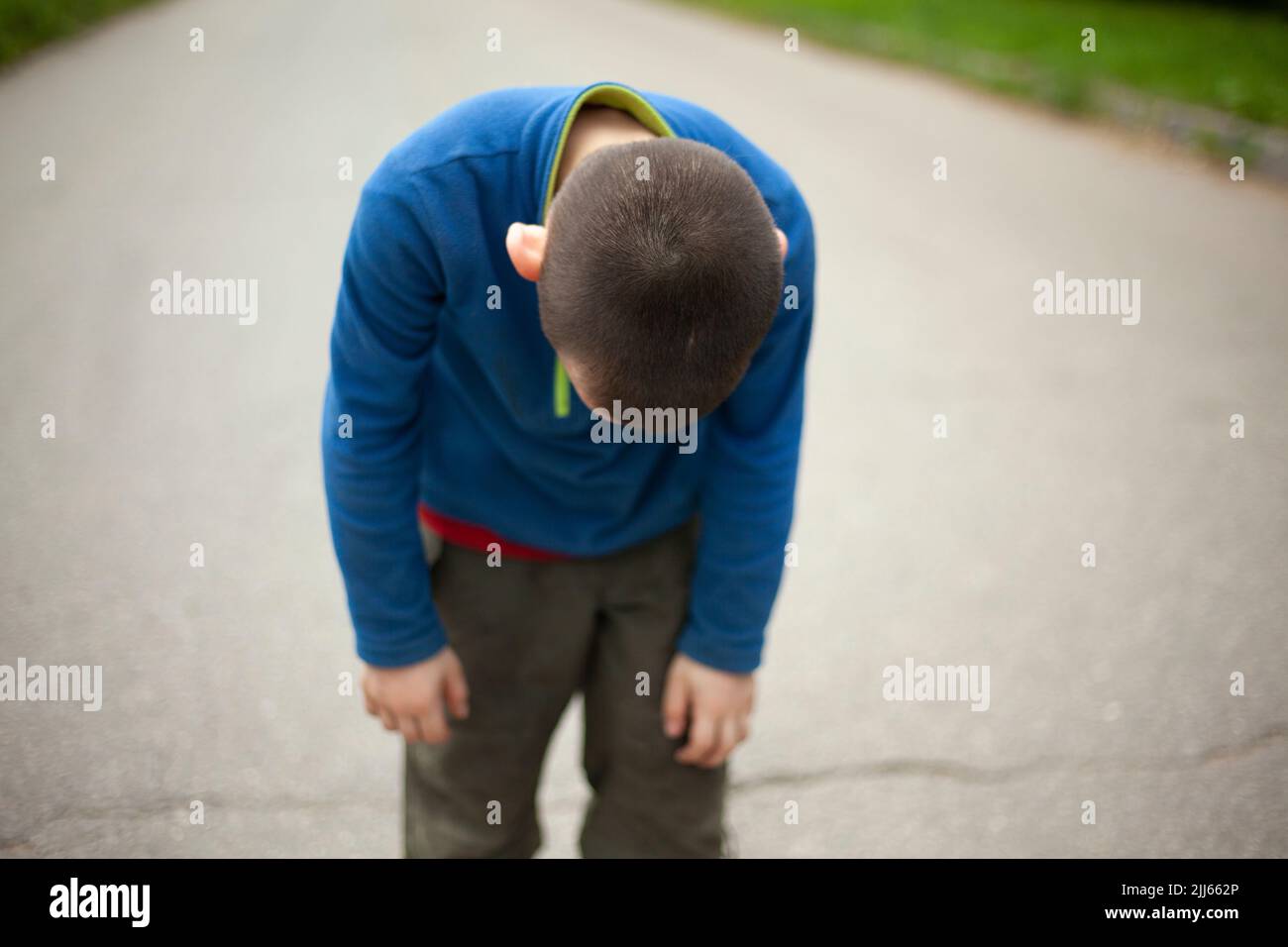 Child lowered his head. Tired boy. Student was upset. Child without ...