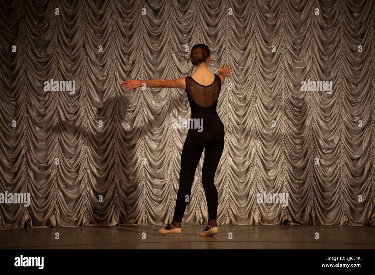 Gymnast in motion. Girl dances. Performance on stage. Dance lesson ...