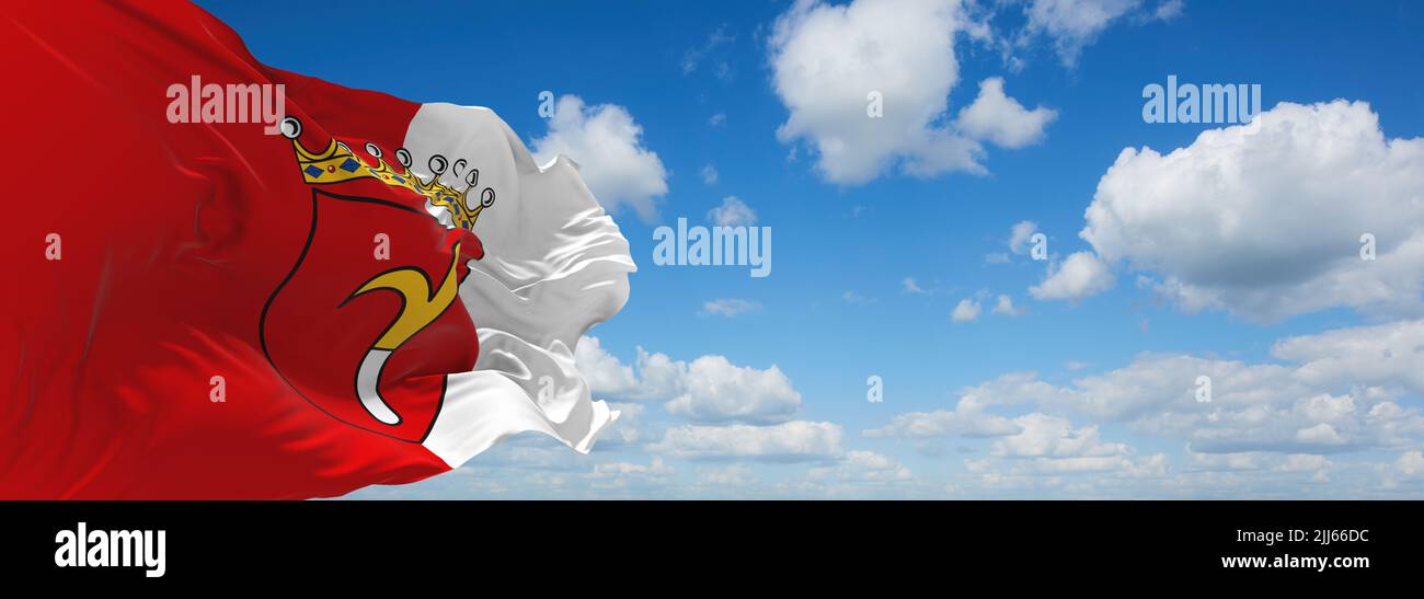 official flag of Mattersburg Austria at cloudy sky background on sunset ...