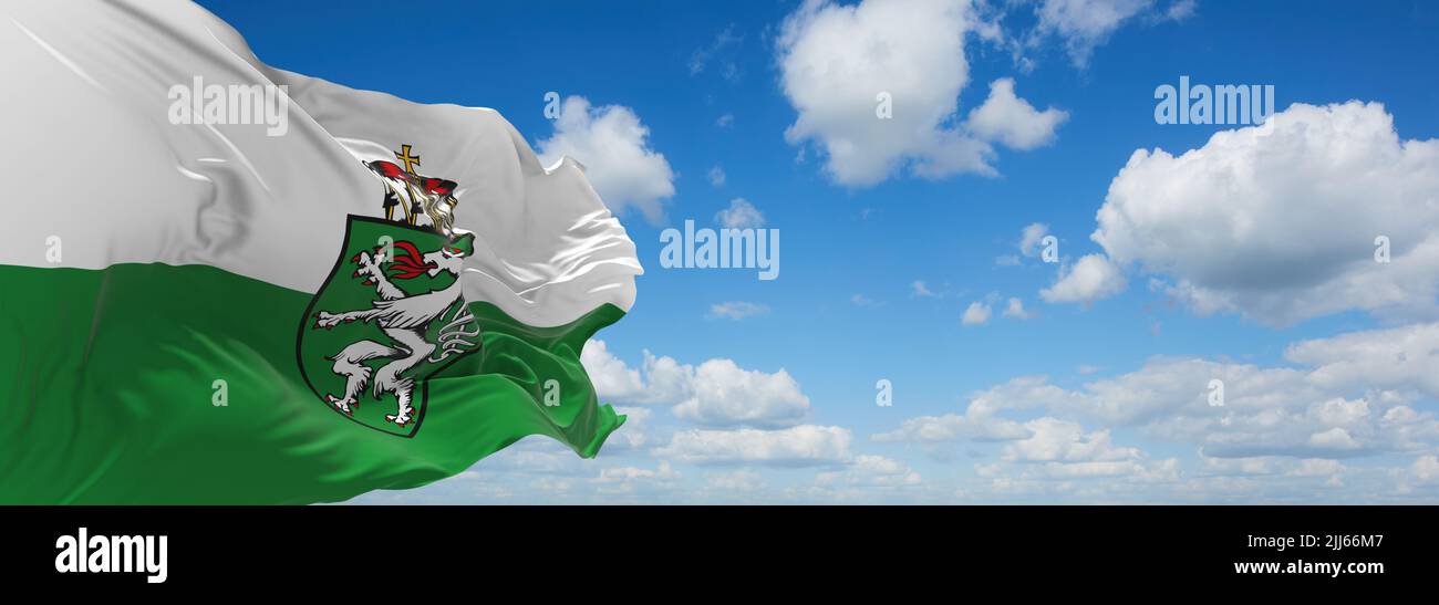 official flag of Styria Austria at cloudy sky background on sunset ...