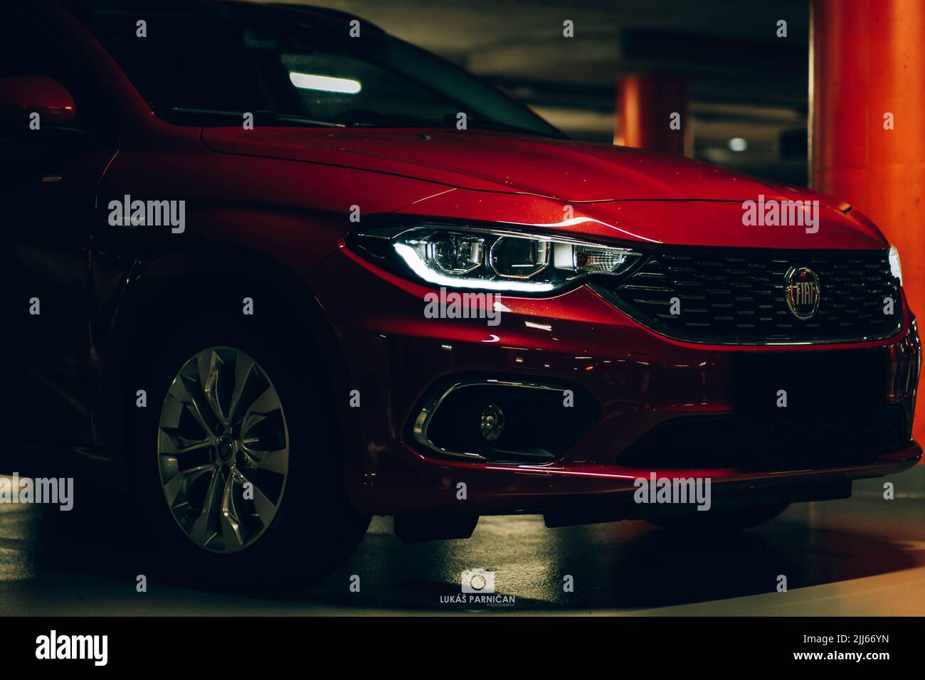 Beautiful red fiat tipo parked in a dark garage with stunning lead ...