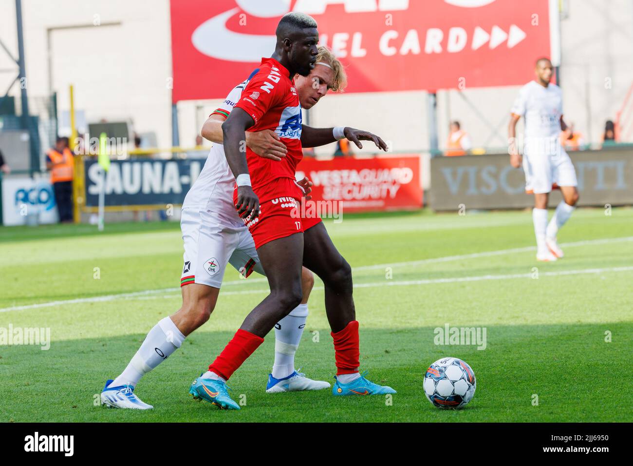 OHL's Ewoud Pletinckx and Kortrijk's Pape Habib Gueye fight for the ball during a soccer match ...