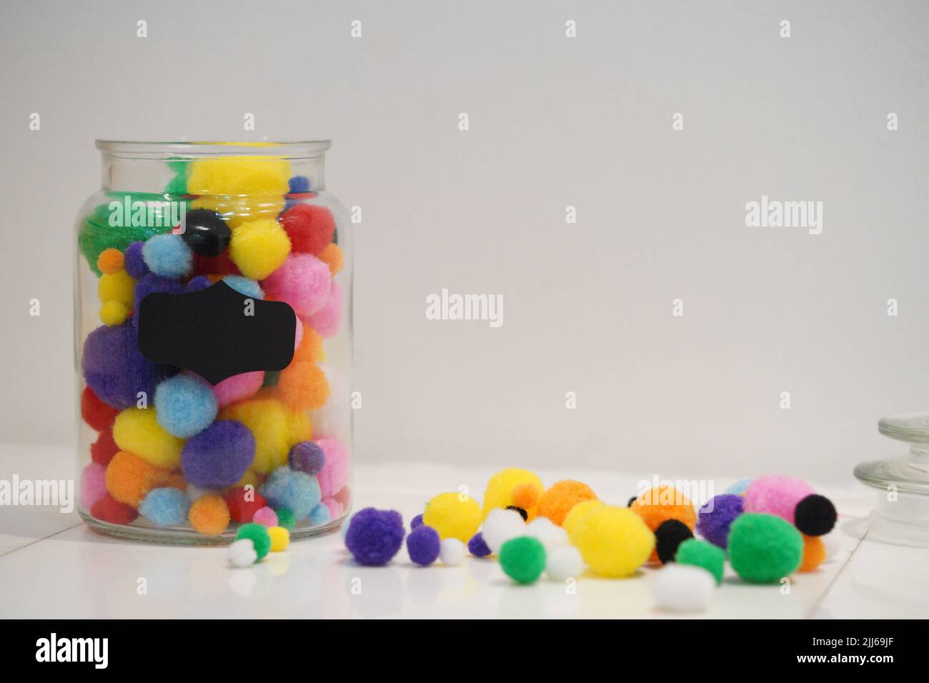Colourful pom pom on a jar with background space for text. Background ...