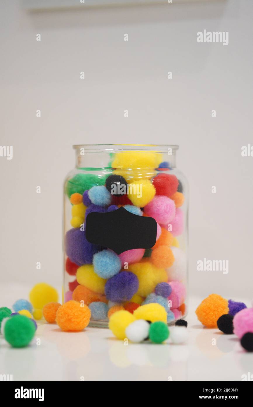 Colourful pom pom on a jar with background space for text. Background ...