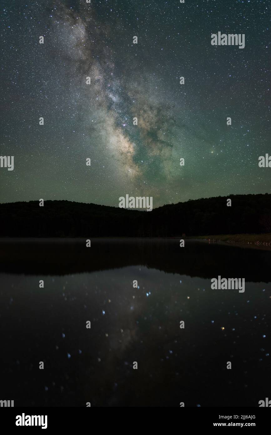 The Milky Way reflects in Spruce Knob Lake as the dark sky reveals the ...