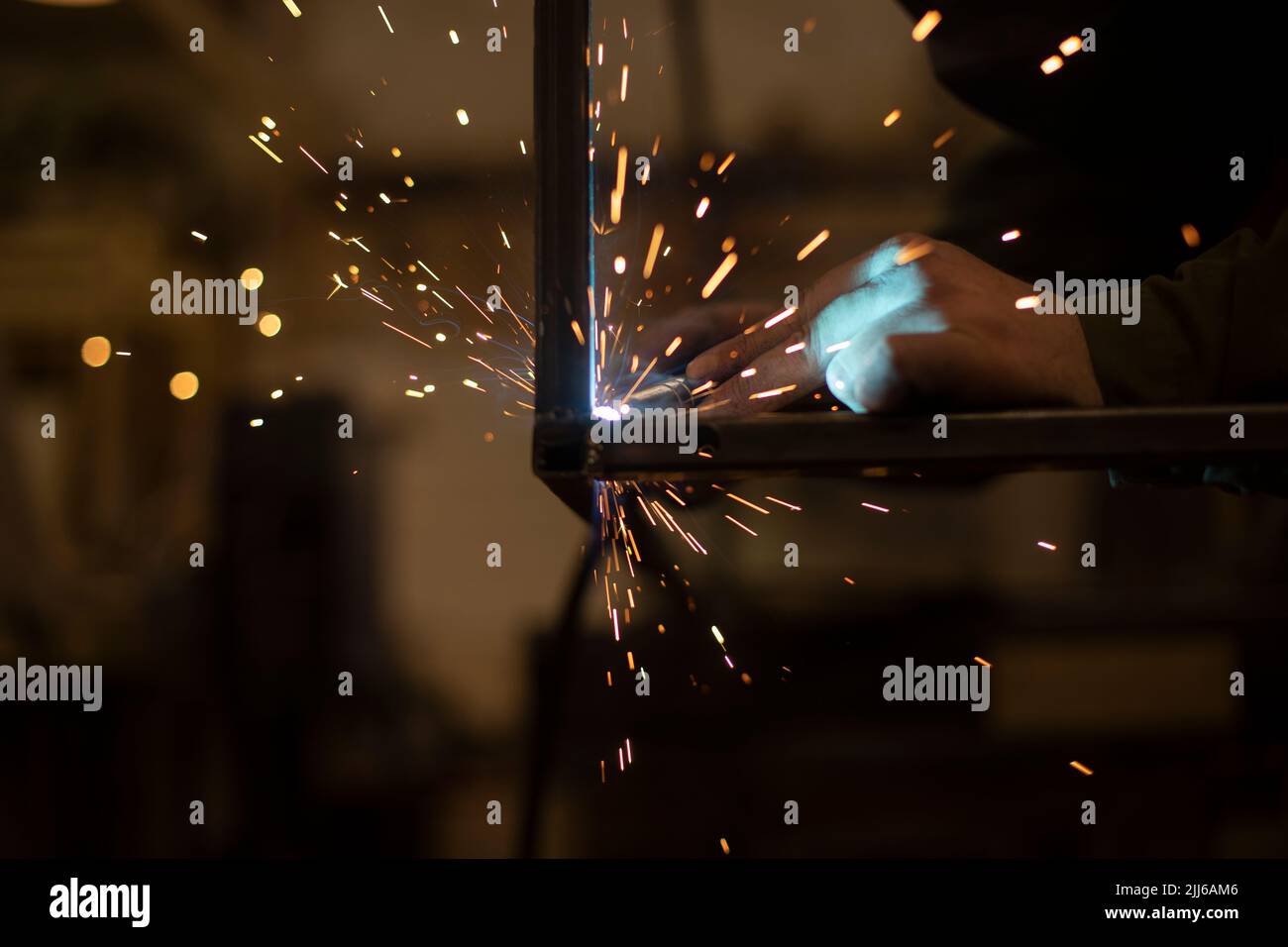 Welding steel in garage. Production details. Creation of welding seam ...