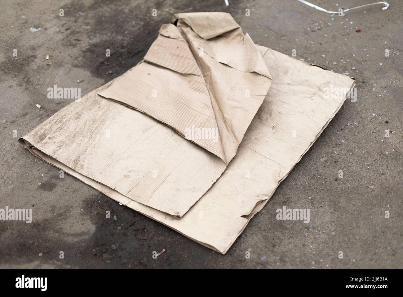 Old cardboard on asphalt. Abandoned box. Garbage on road. Spoiled ...