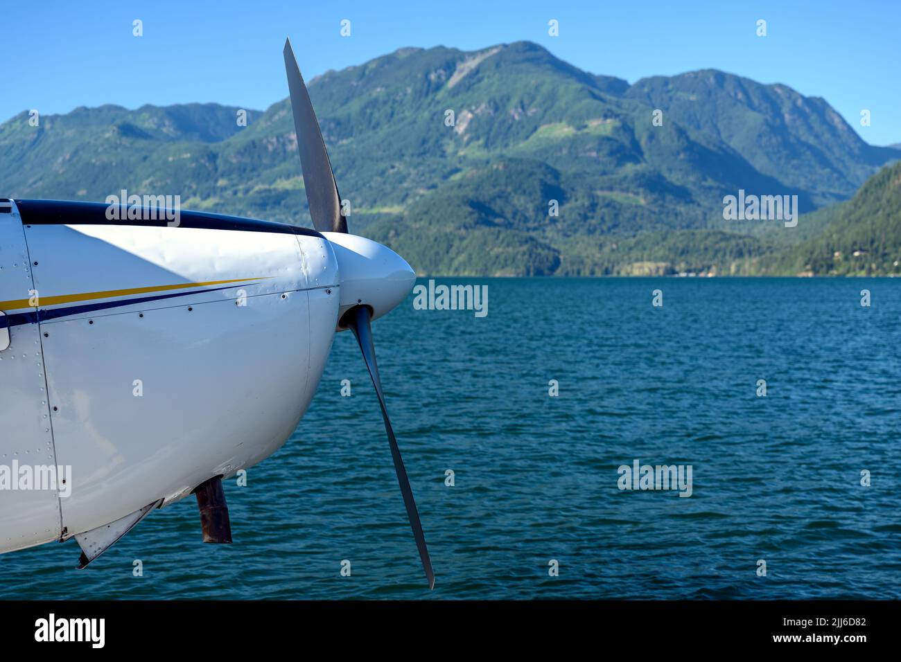 Hydroplane tied to the water aerodrome on Harrison Lake over blue sky ...