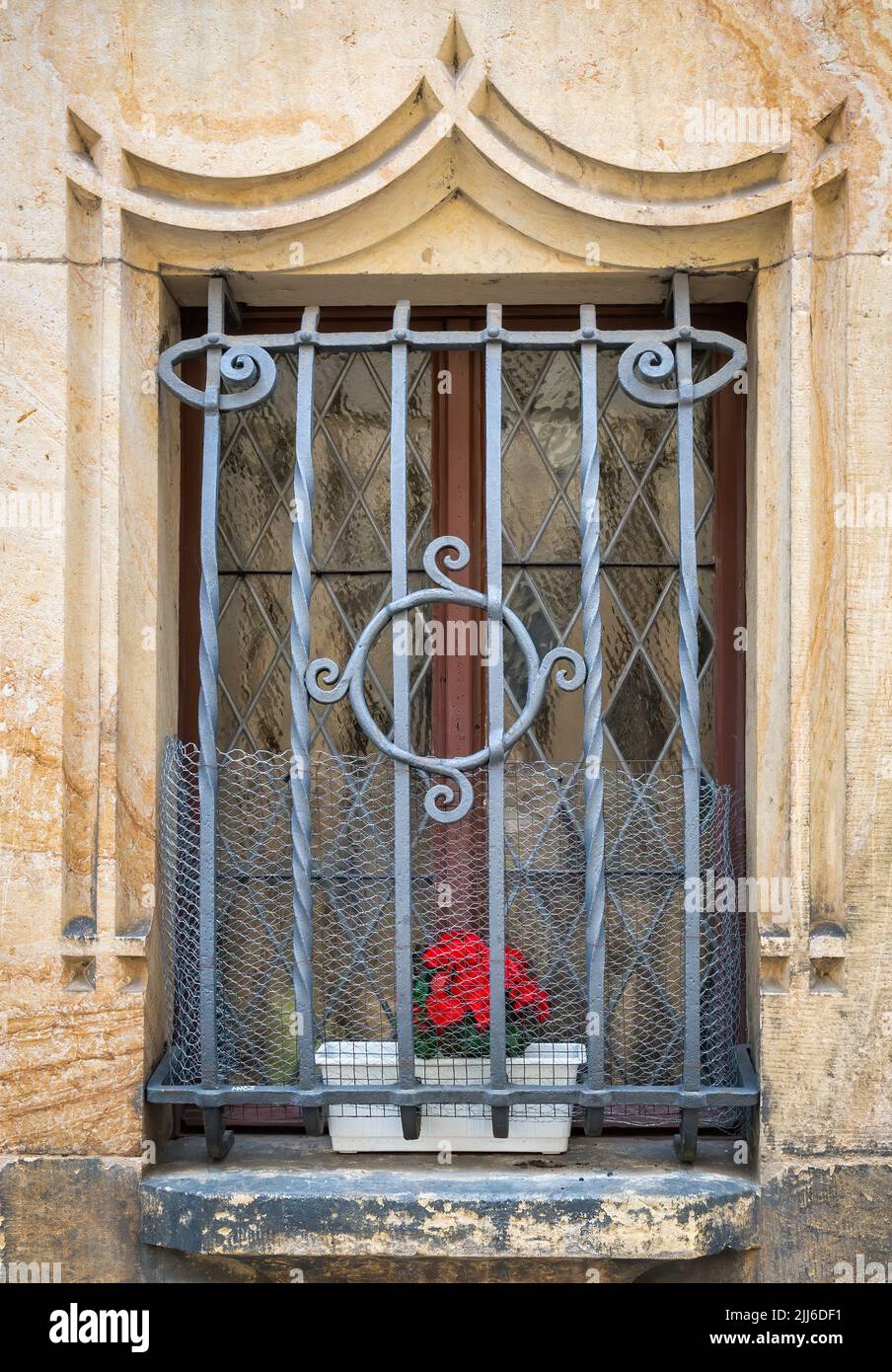 Detail with an old medieval window with metal security iran bars Stock ...