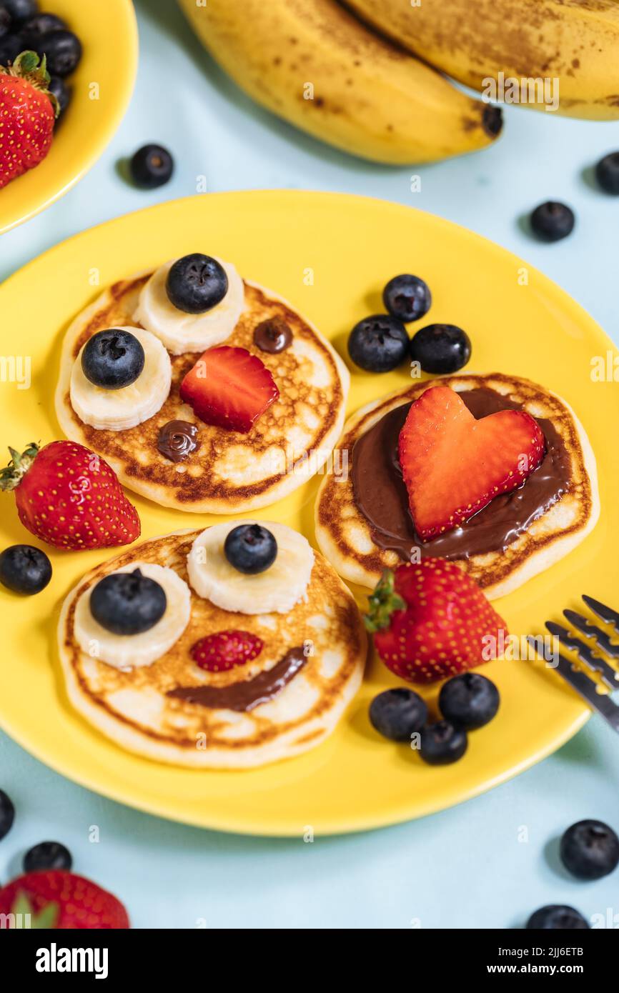 American pancakes decorated like smile and happy faces with ...