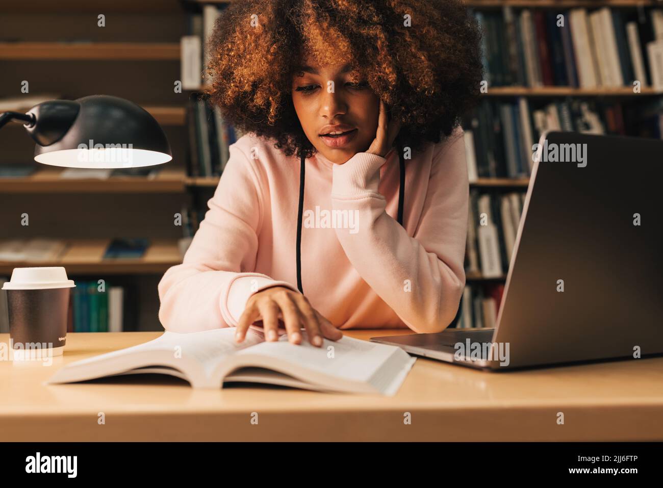 African girl reading library book hi-res stock photography and images ...