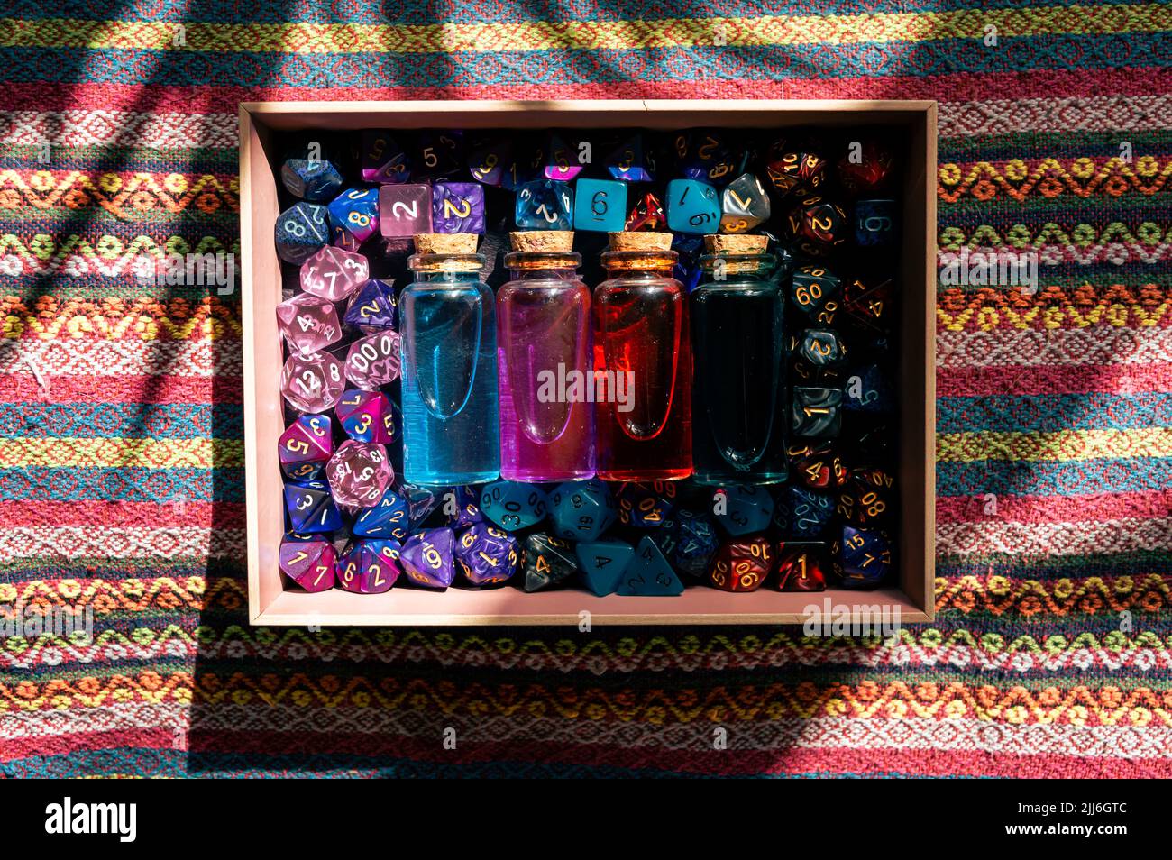 Overhead image of a dice tray filled with rpg role playing dice and ...
