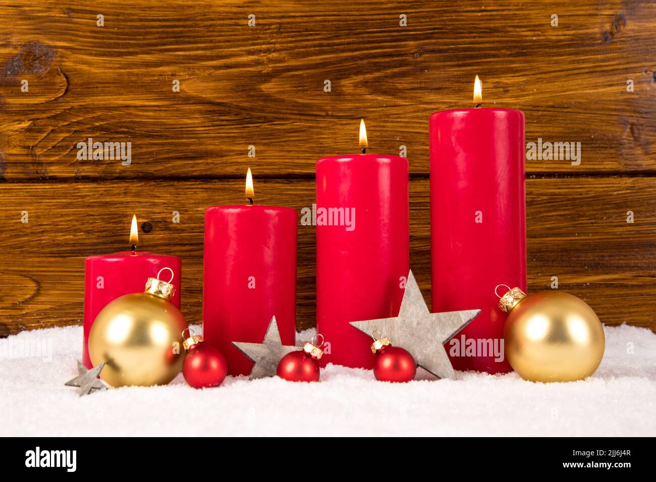 The four advent candles with christmas balls and stars Stock Photo - Alamy