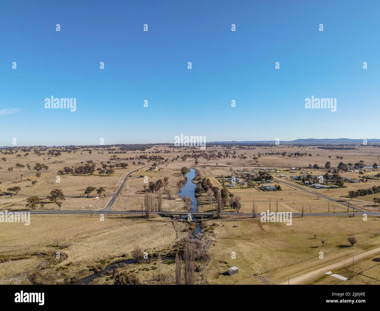 A drone shot overlooking natural landscapes with a bridge and narrow ...