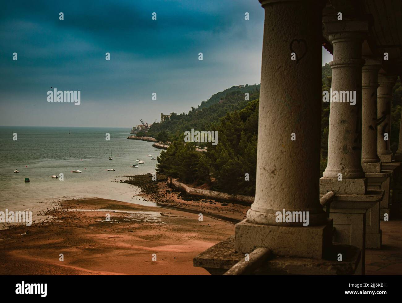 A beach seen from the balcony with columns Stock Photo - Alamy