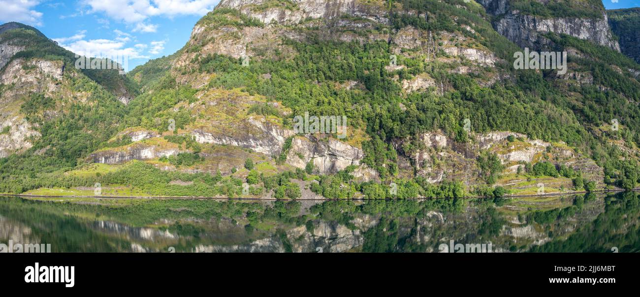 Reflection in the still Fjord water near the Norwegian town for Flam at ...