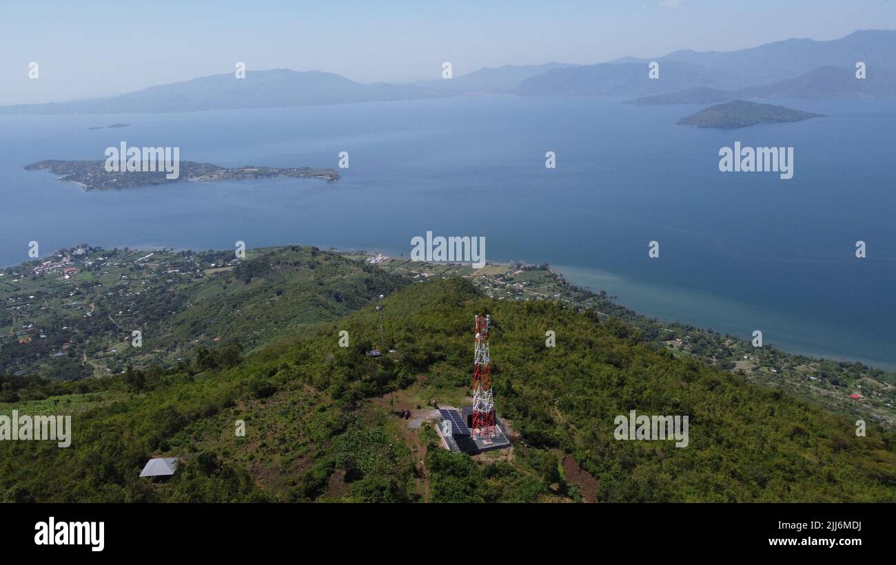 An aerial view of a telecommunication tower and solar panels on top of ...