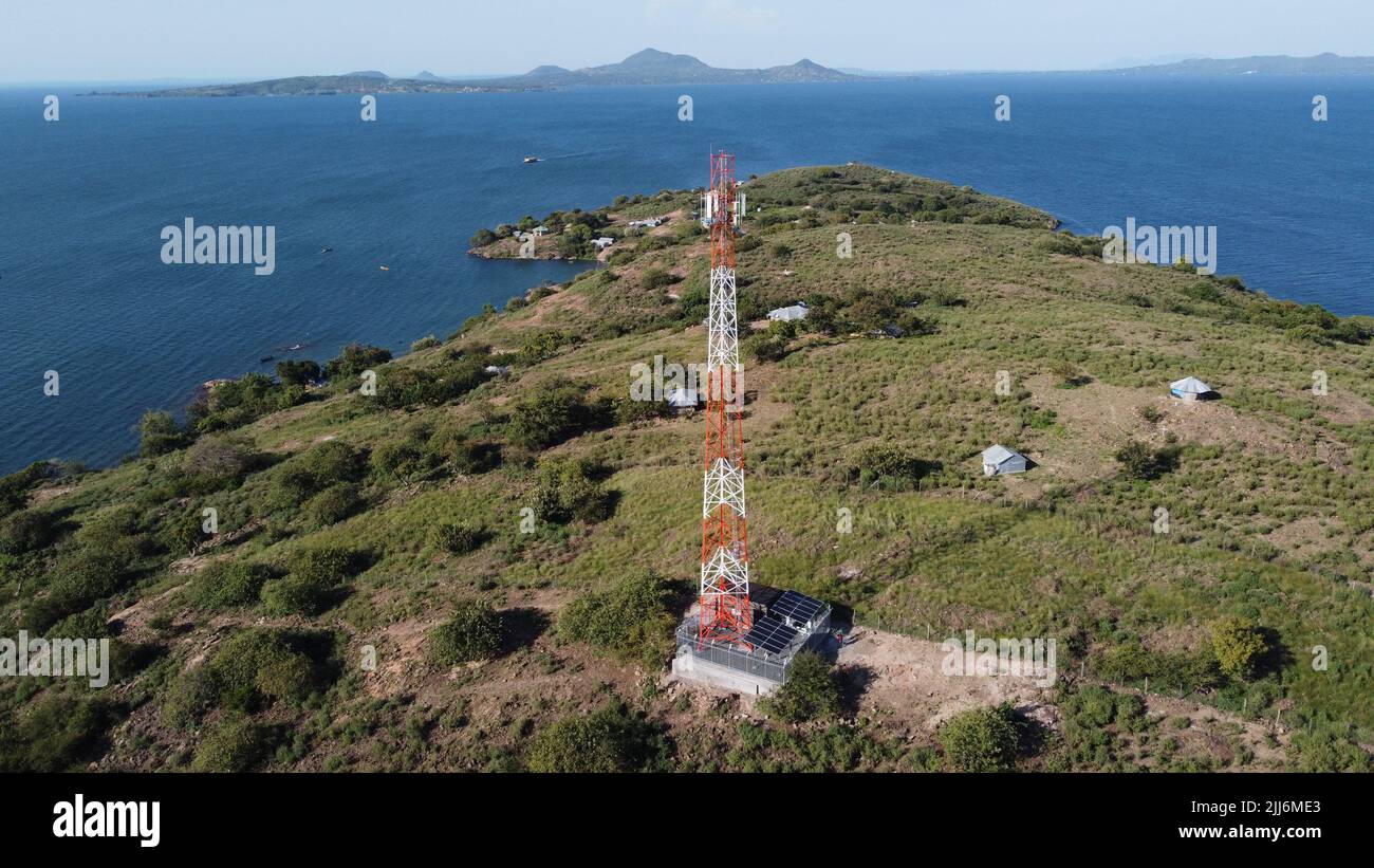 An aerial view of a telecommunication tower and solar panels on top of ...