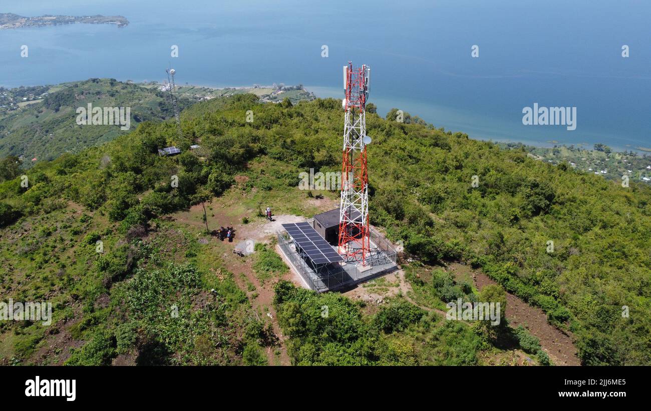 An aerial view of a telecommunication tower and solar panels on top of ...
