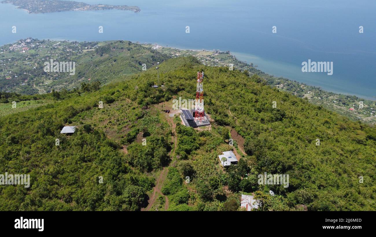 An aerial view of a telecommunication tower and solar panels on top of ...