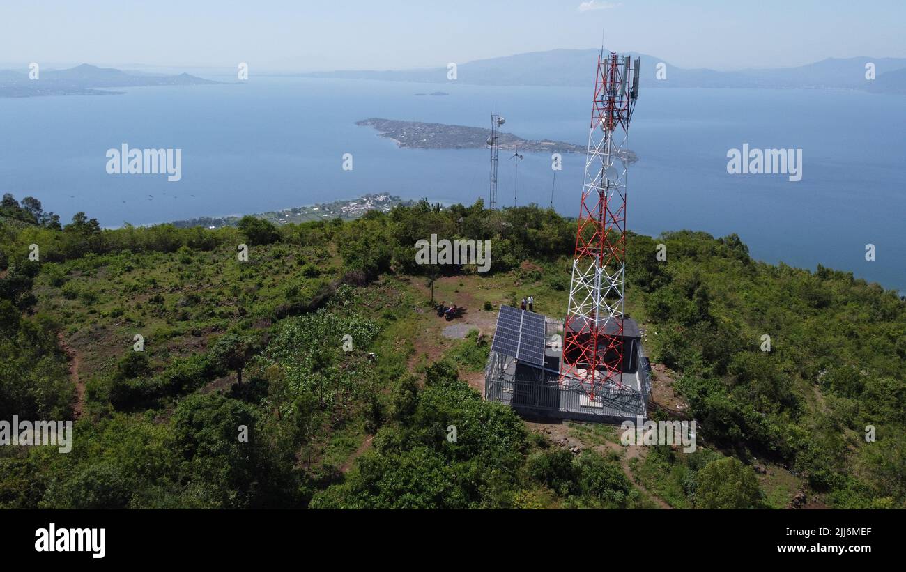 An aerial view of a telecommunication tower and solar panels on top of ...