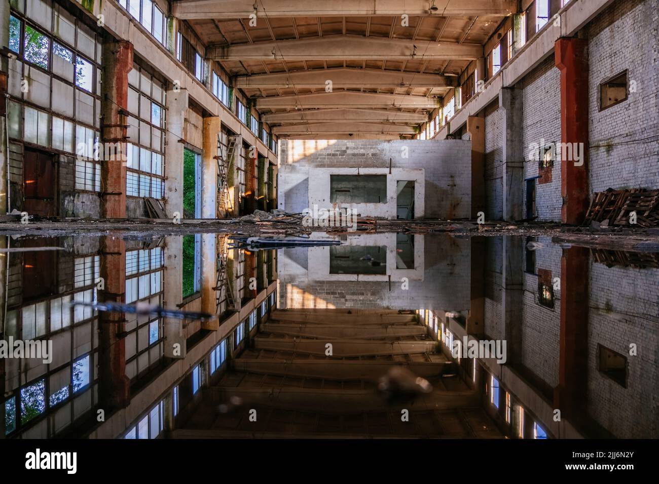 Inside of flooded dirty abandoned ruined industrial building with water ...
