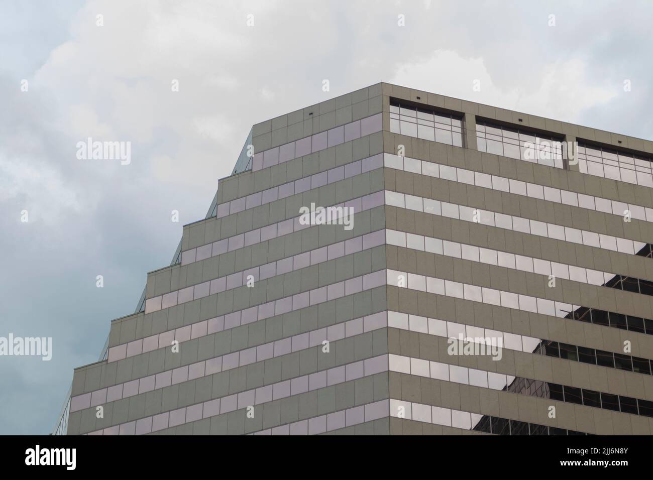 The top floors of a modern glazed building with stepped terraces Stock ...