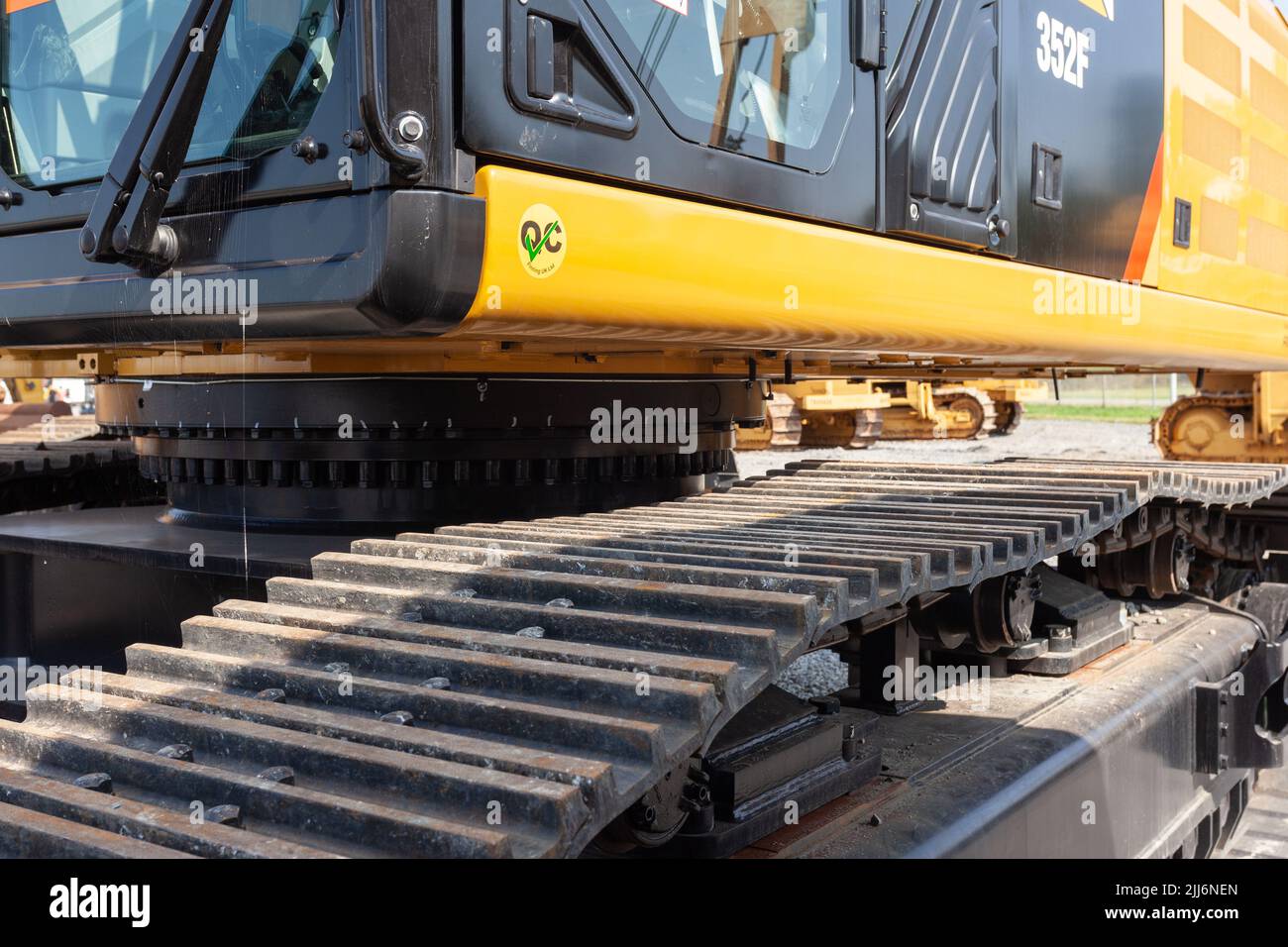A closeup of yellow excavator's tracks Stock Photo - Alamy