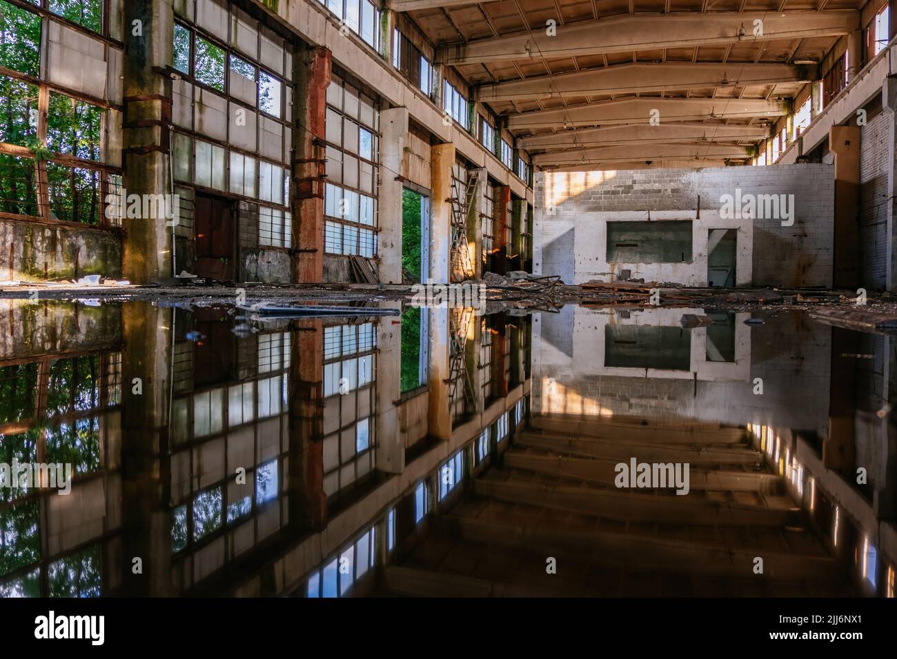 Inside of flooded dirty abandoned ruined industrial building with water ...