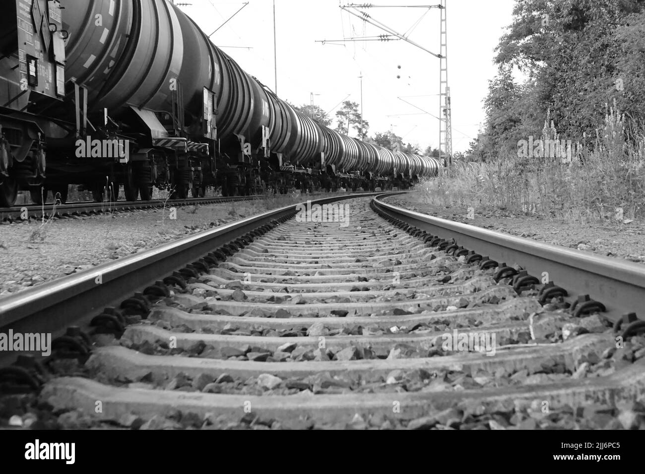 The grayscale view of the cargo train with oil tanker cars Stock Photo ...
