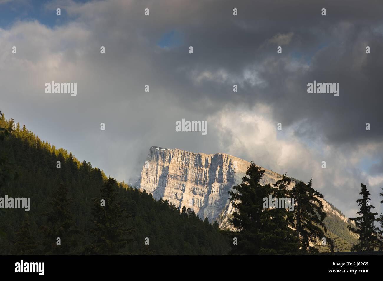 Moody, atmospheric landscape view with dramatic light on the peak of ...