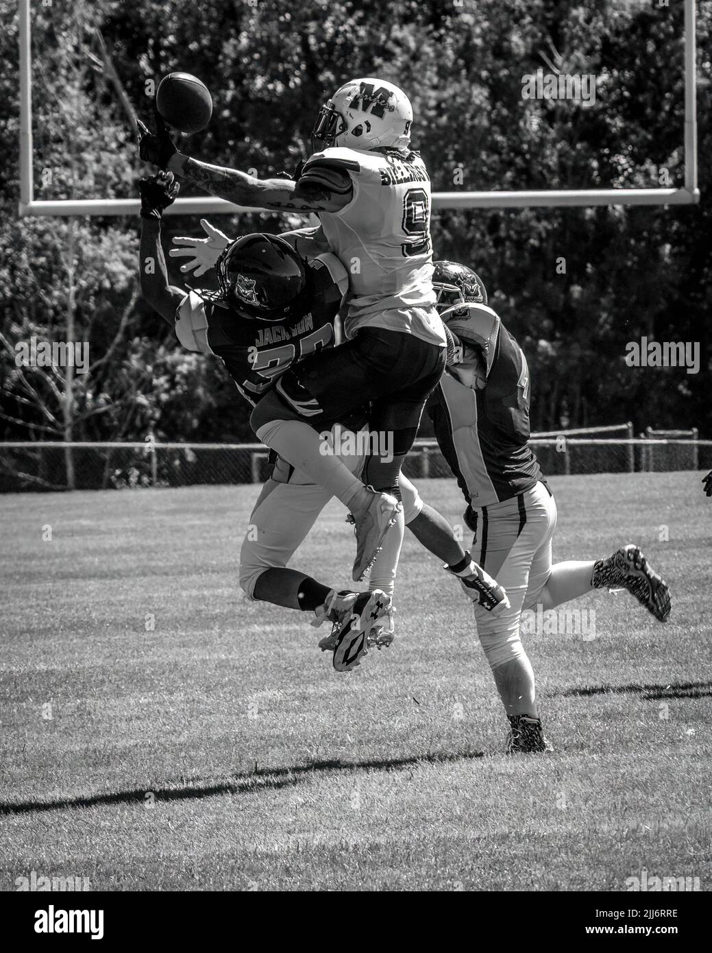 an American football player making a leaping grab during a game Stock ...