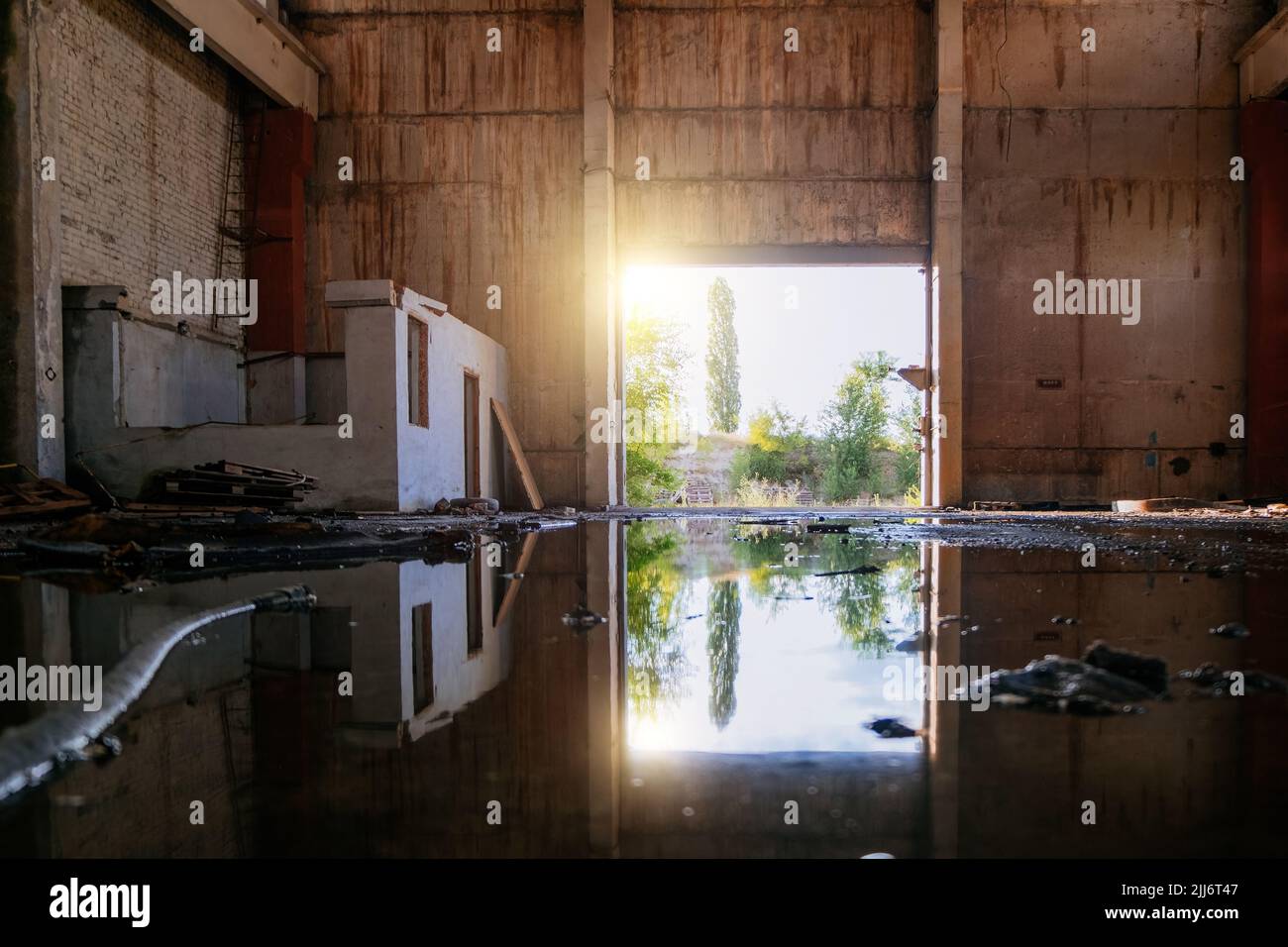 Inside of flooded dirty abandoned ruined industrial building with water ...