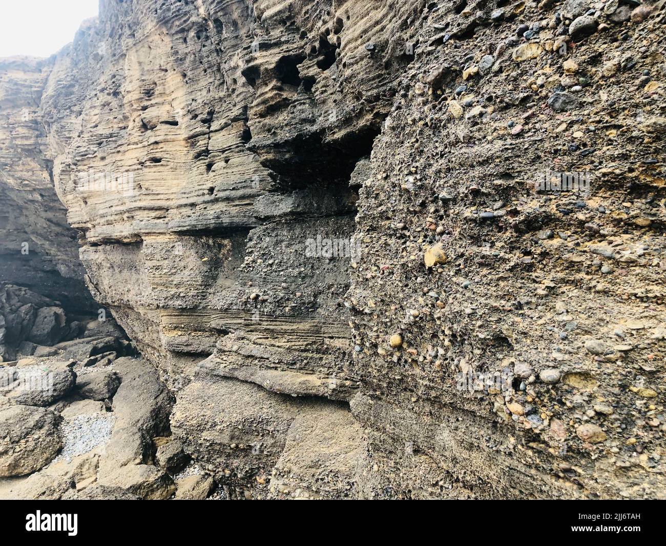Tall rocky cliffs of a beach Stock Photo - Alamy