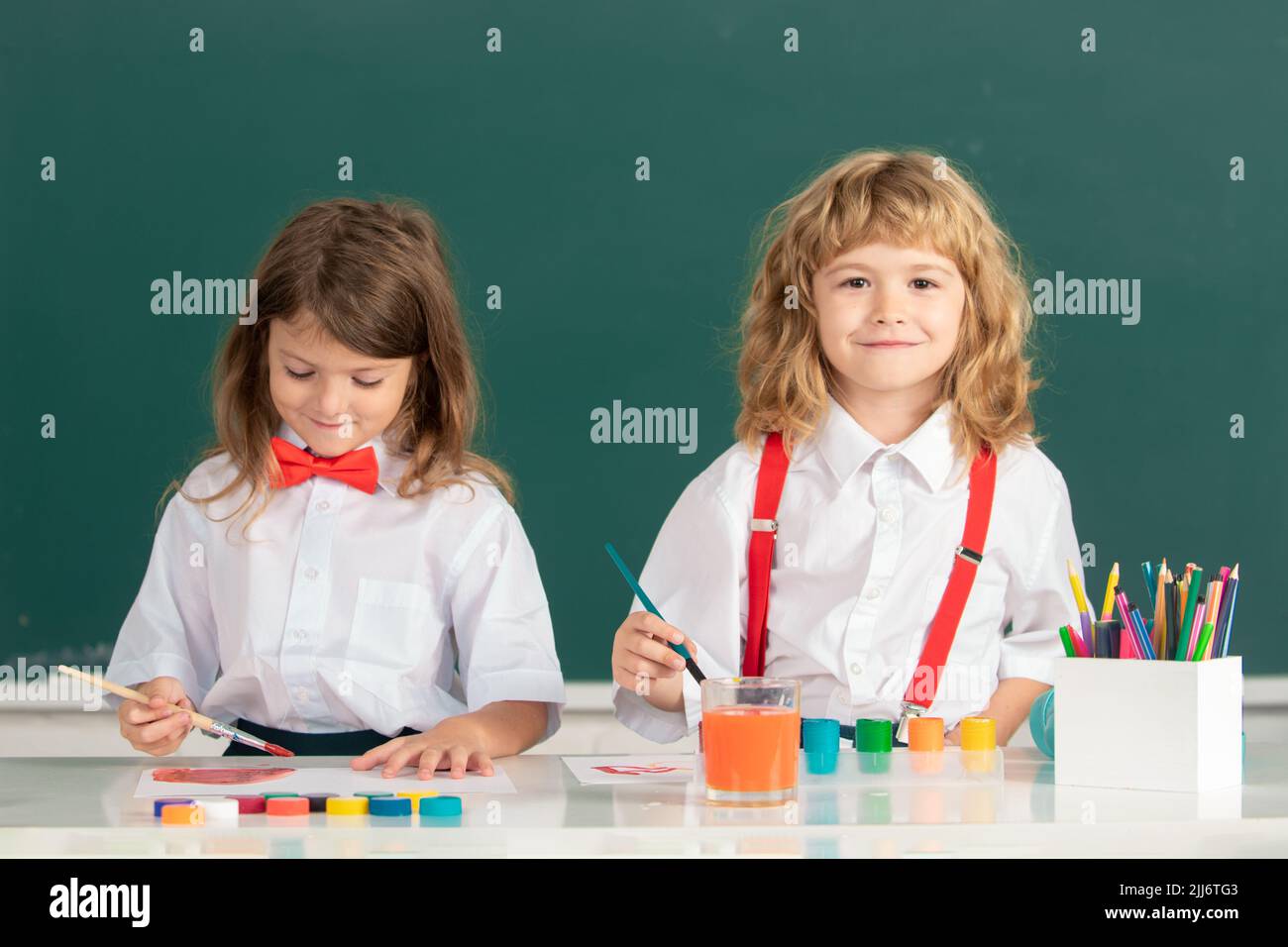 Portrait school kids doing art homework. Children drawing on elementary ...