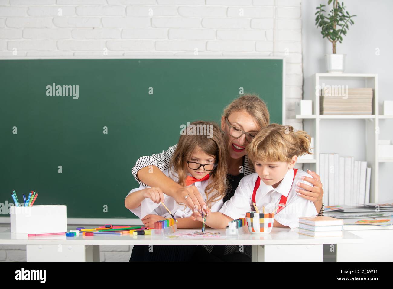 Schoolkids with teacher. Happy children from elementary school study at ...