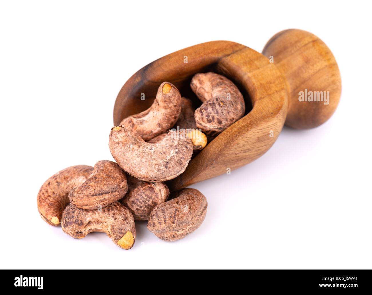 Cashew nuts in shell in wooden scoop, isolated on white background ...