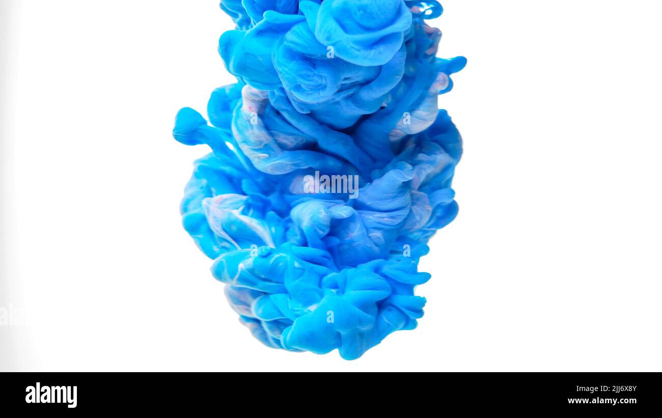 the Blue color paint pouring in water isolated on white background ...