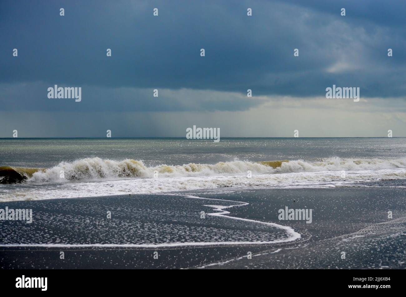 The soft ocean waves with foam on a Cocoa sandy beach Stock Photo - Alamy
