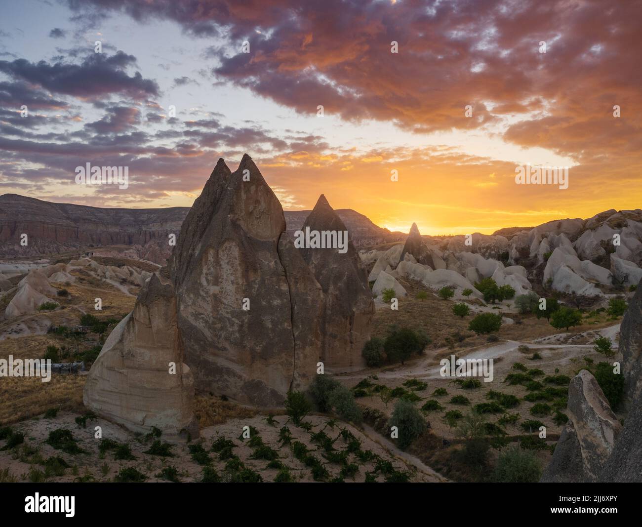 The huge rocks with sharp peaks at scenic sunset in Cappadocia, Turkey ...