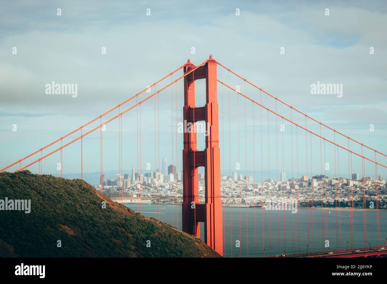 A beautiful closeup of a Golden Gate Bridge tower on a city background ...