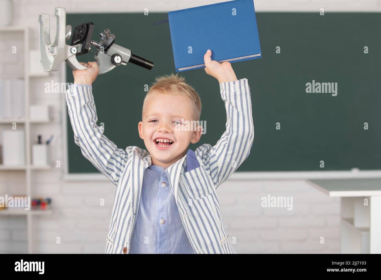 Little schoolboy study in a classroom at elementary school. Excited ...