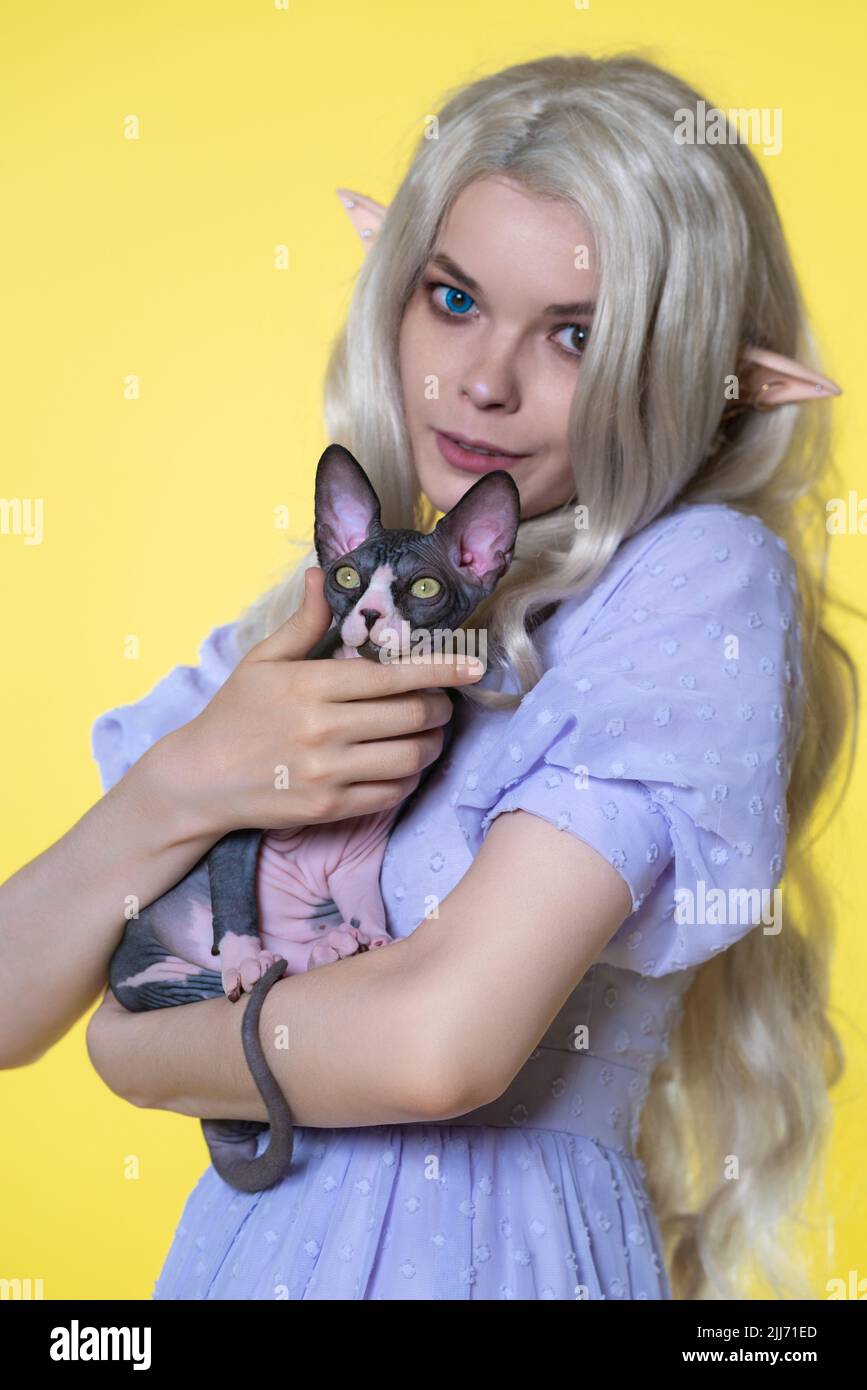 Young woman cosplay elf in blue summer dress, with blonde long hair and ...