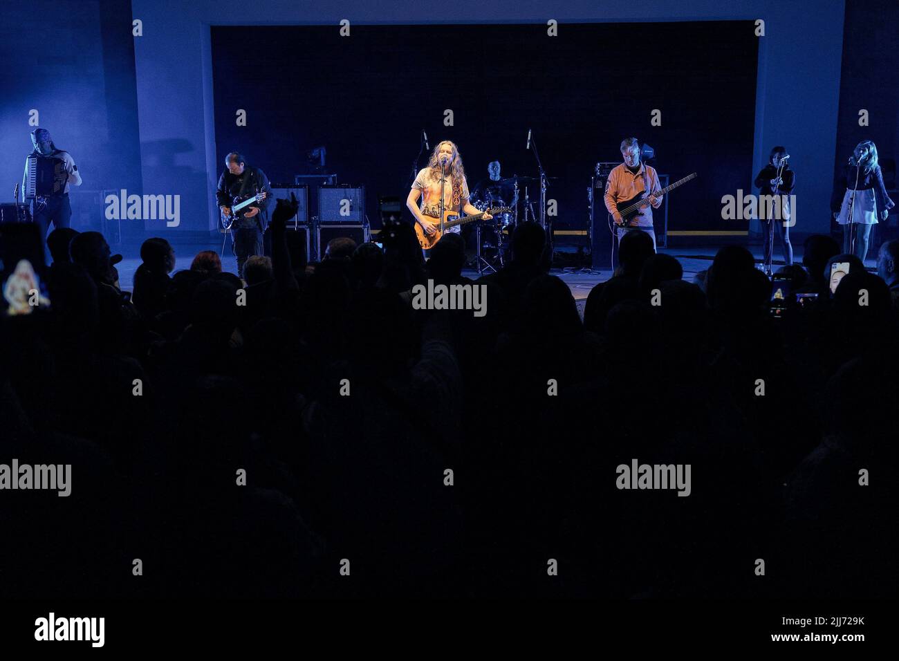The Chizh & Co band performs on stage in front of a packed concert ...