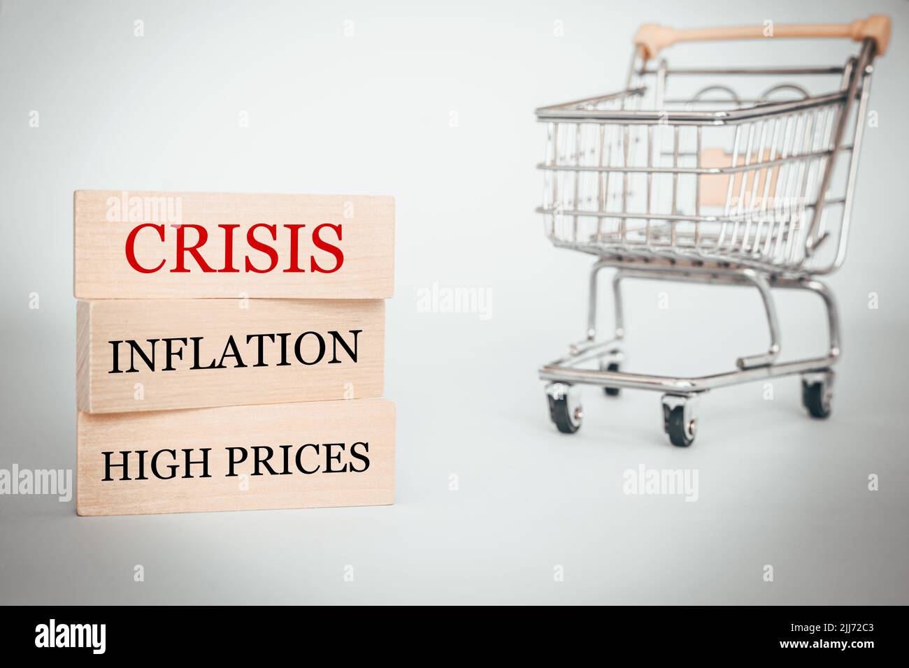 Slogans written on wooden blocks, Crisis, Inflation and high prices ...