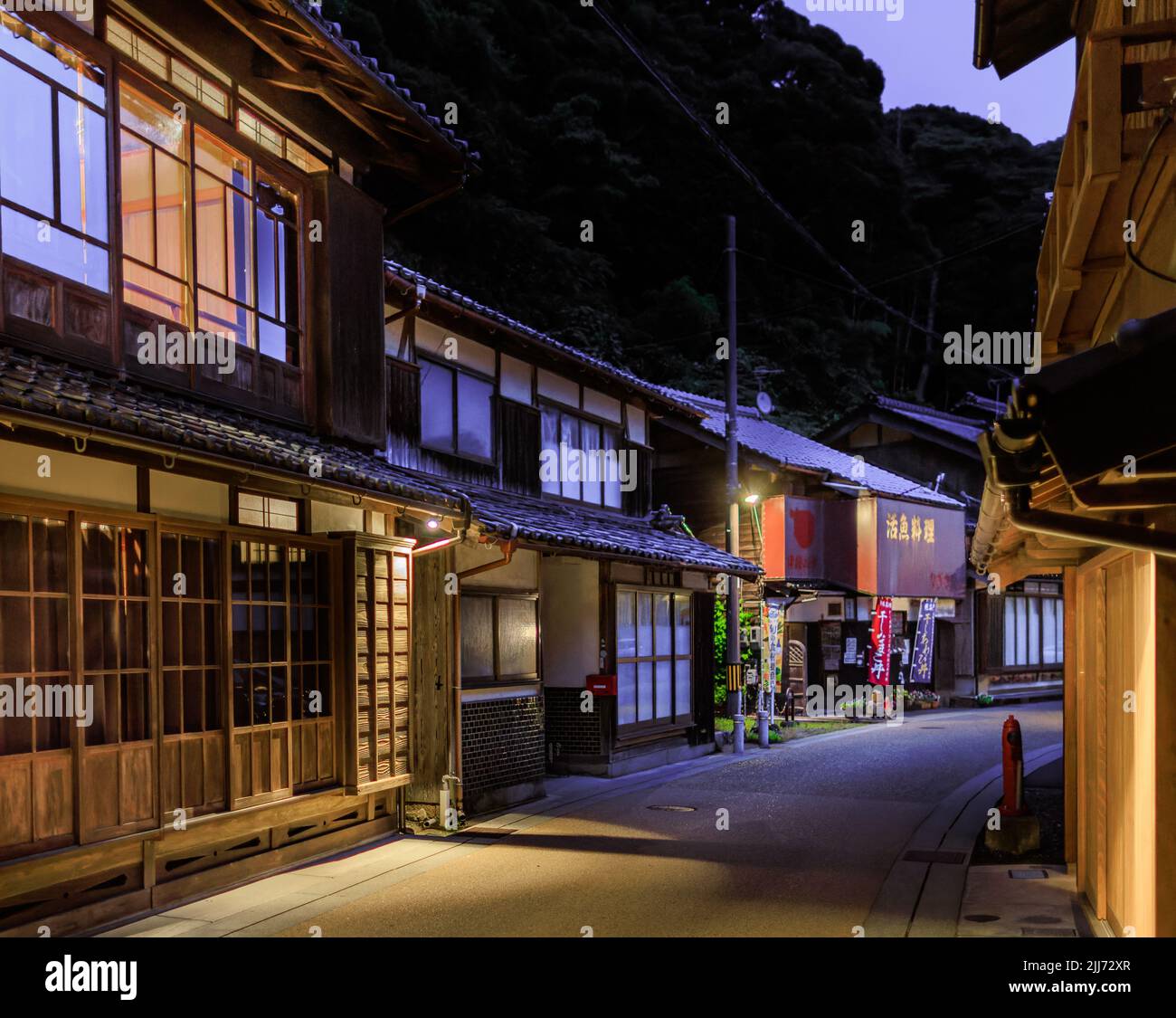 Wooden buildings line empty street in traditional Japanese village at ...