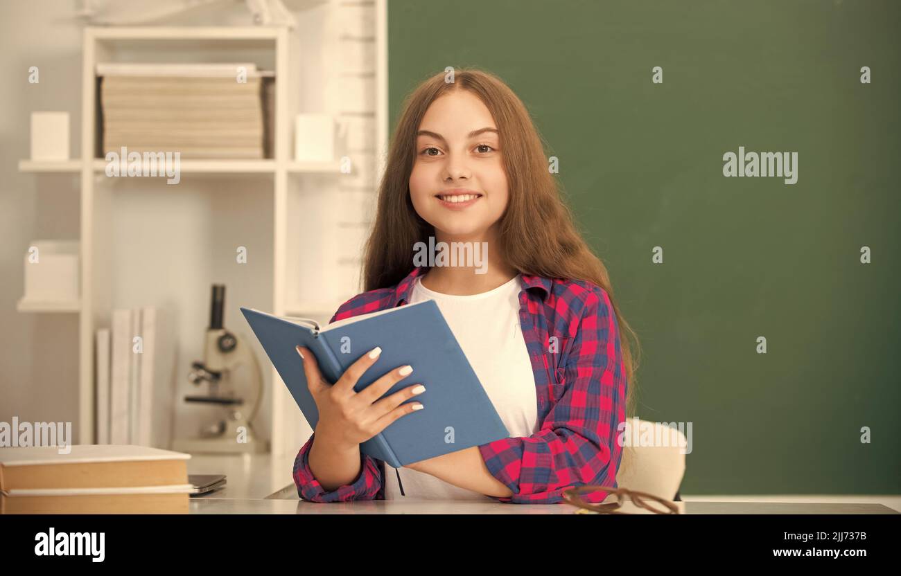 happy child study with book at school on blackboard background, wisdom ...