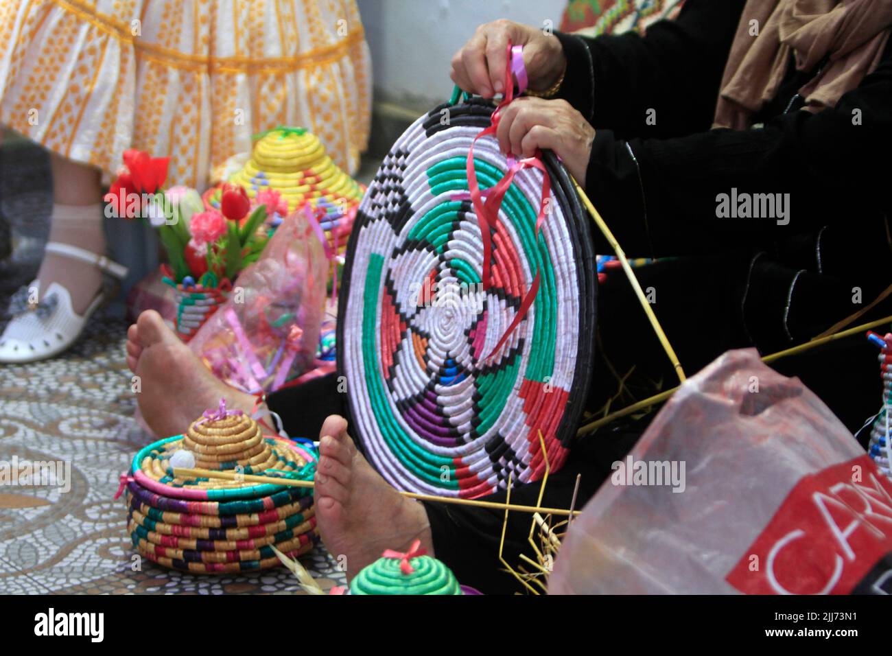A handmade craft decoration from straw by an elderly lady to be sold at ...